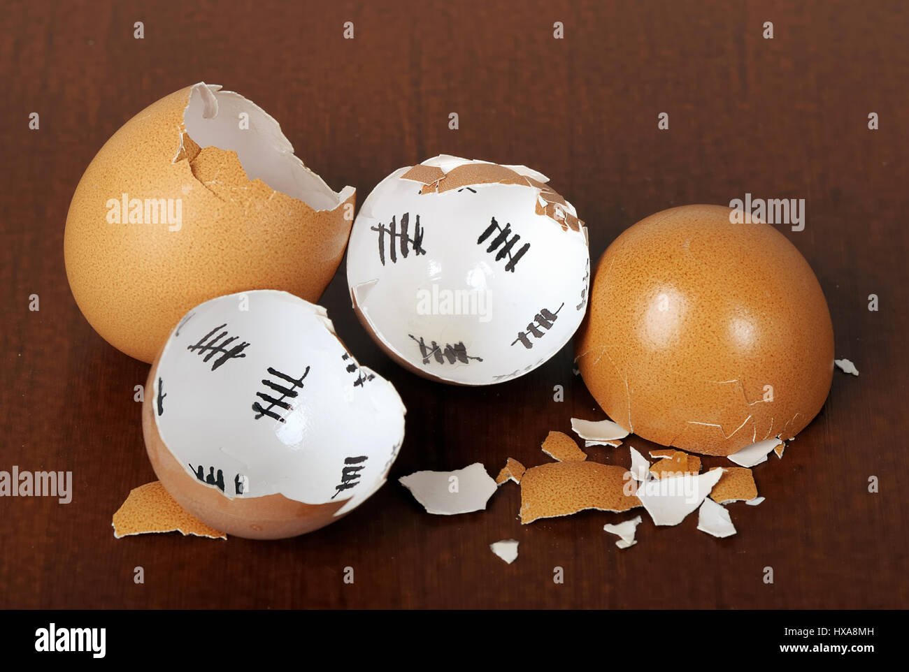 Broken egg shell closeup on brown background Stock Photo - Alamy