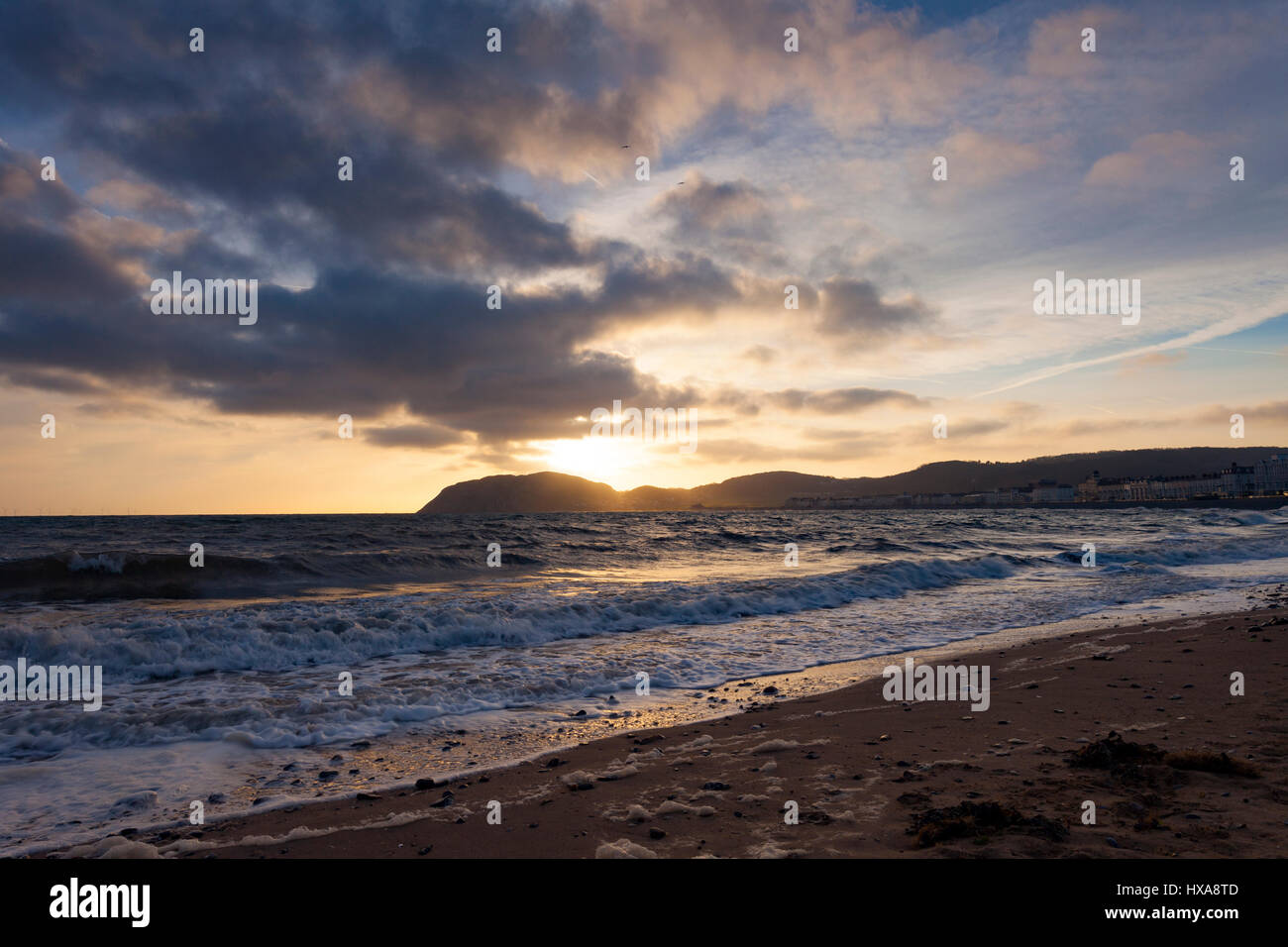 Dawn breaking with a spectacular sunrise over the little orme at the ...