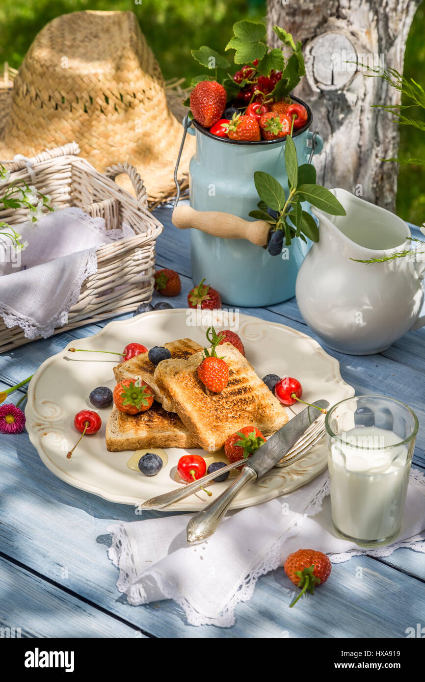 Toast, fruit and honey for breakfast on old wooden table Stock Photo ...