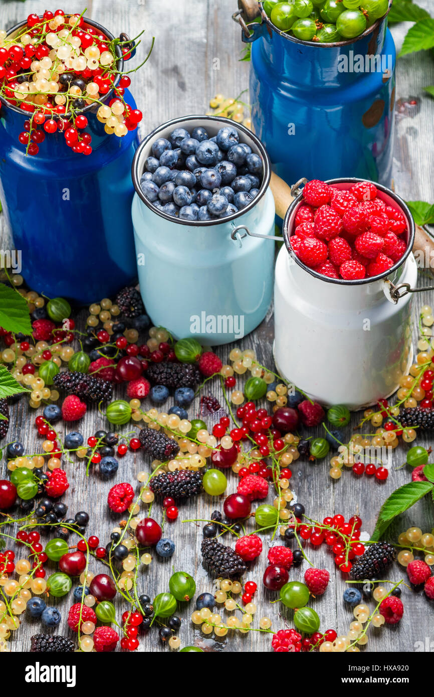 Collecting fresh wild berries on old wooden table Stock Photo - Alamy