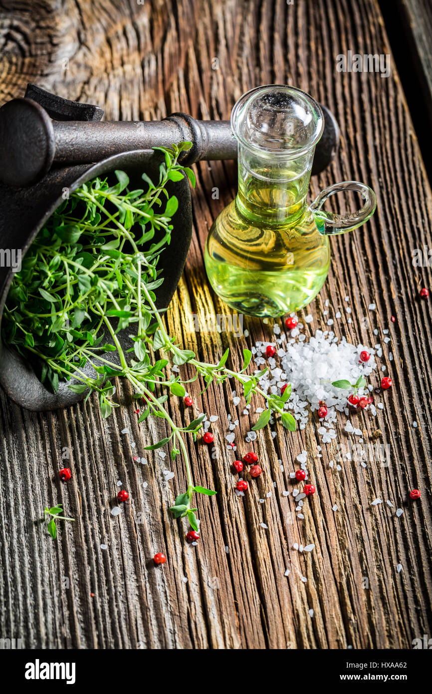 Mortar with vivid condiments on old wooden table Stock Photo - Alamy