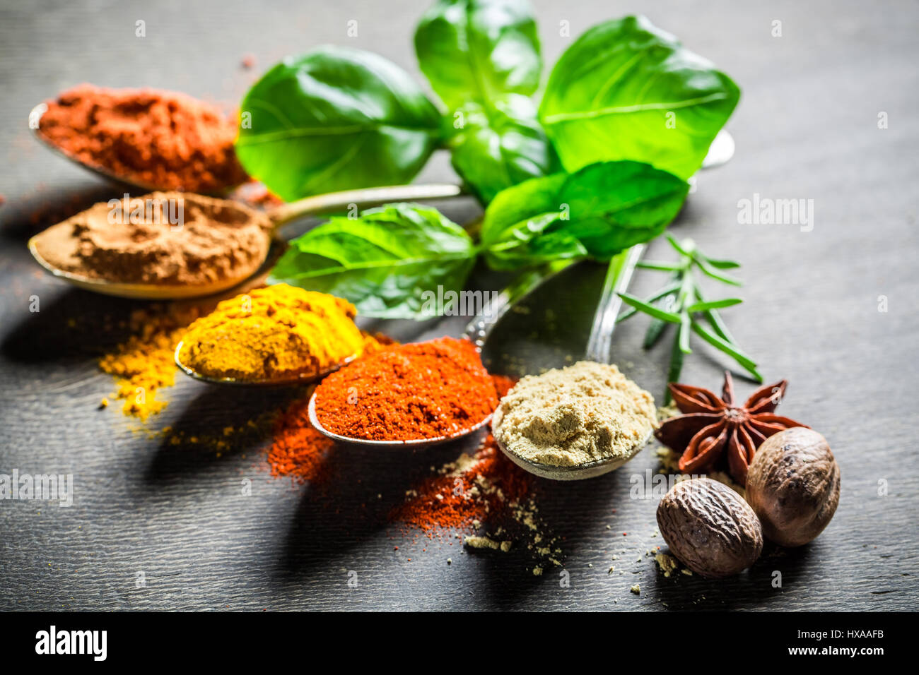 Intensive spices and herbs on old table Stock Photo - Alamy
