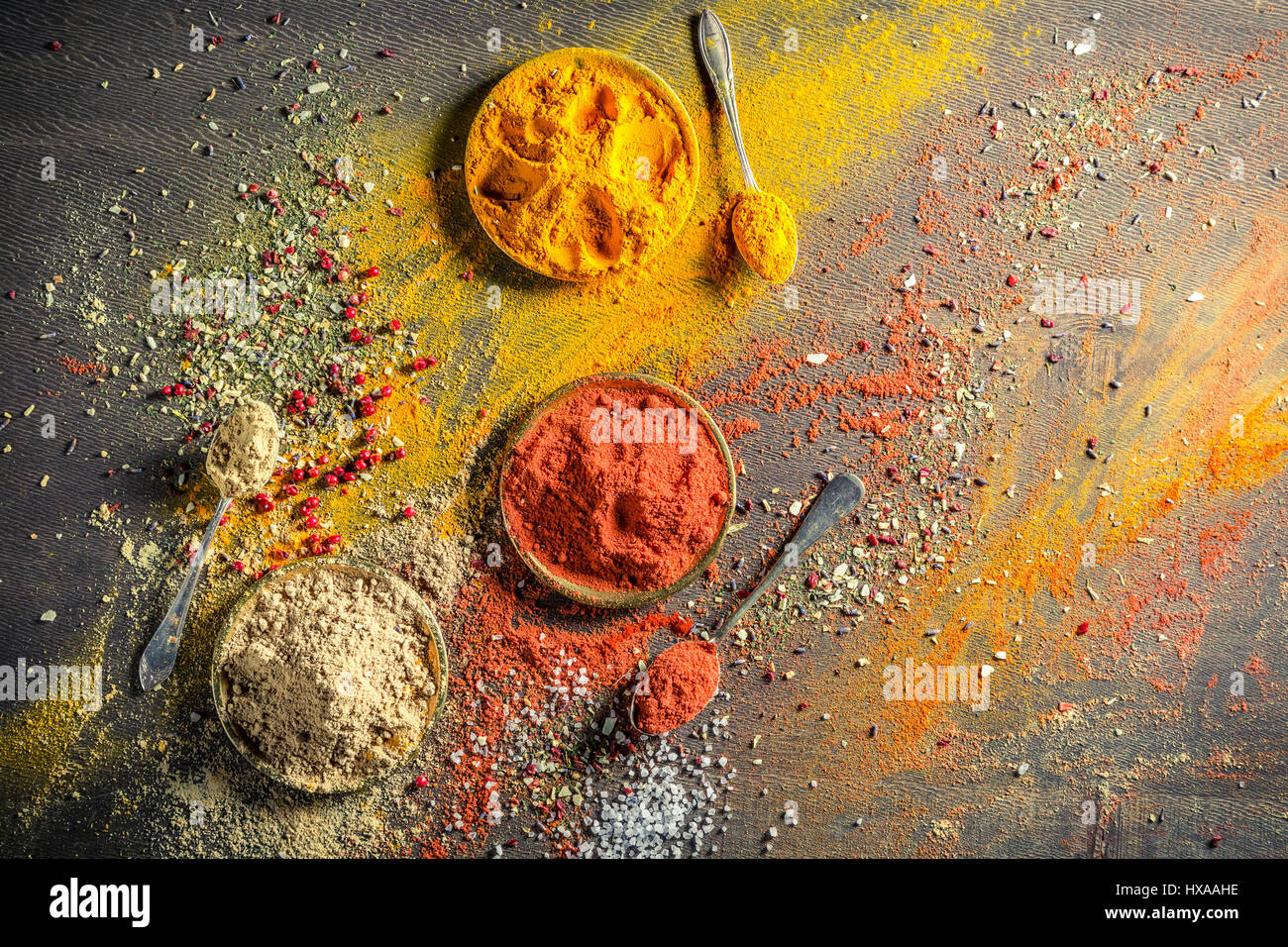Vivid condiments on old wooden table as background Stock Photo - Alamy