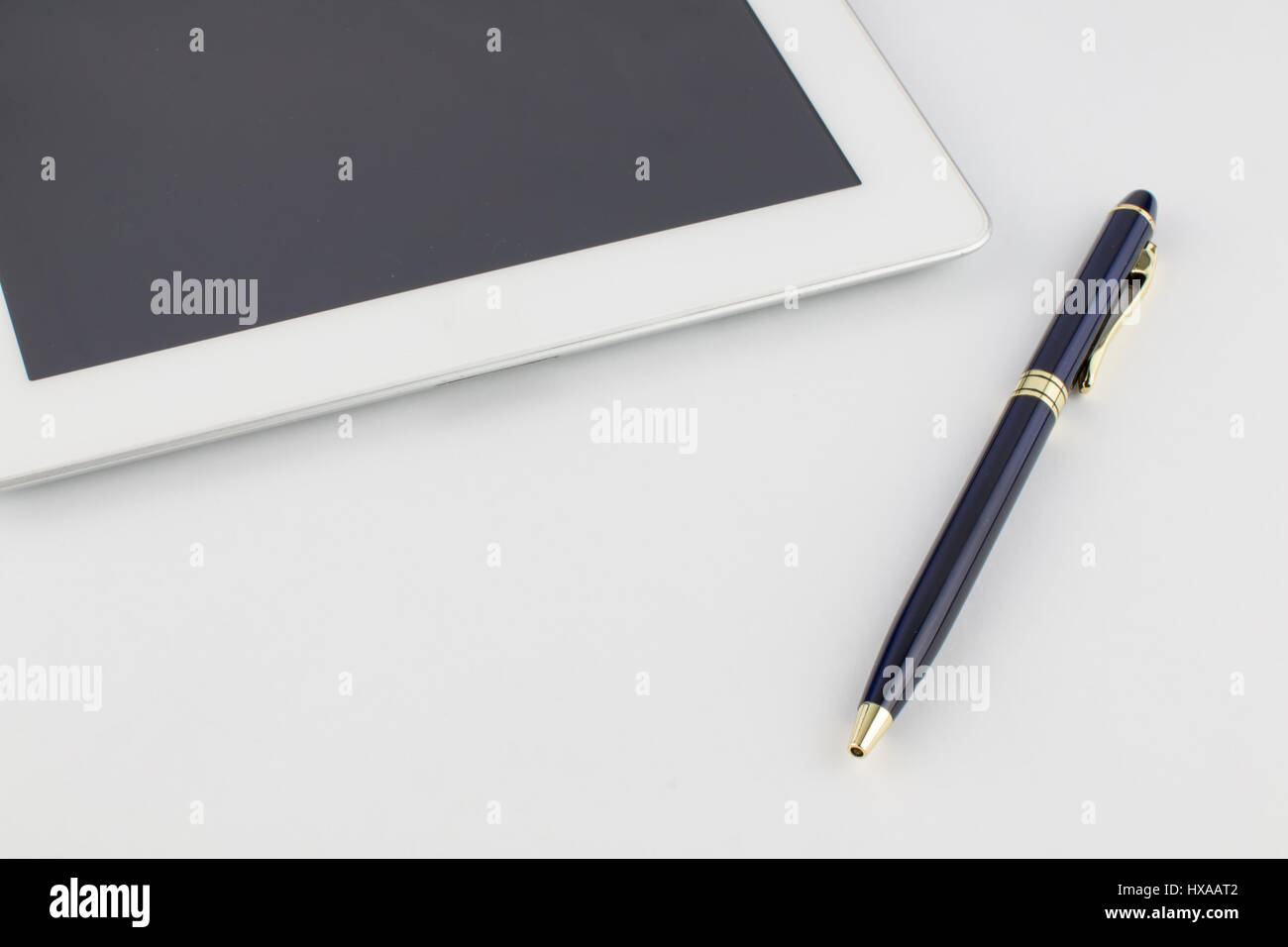 Tablet computer and a modern metal pen on a white background Stock ...