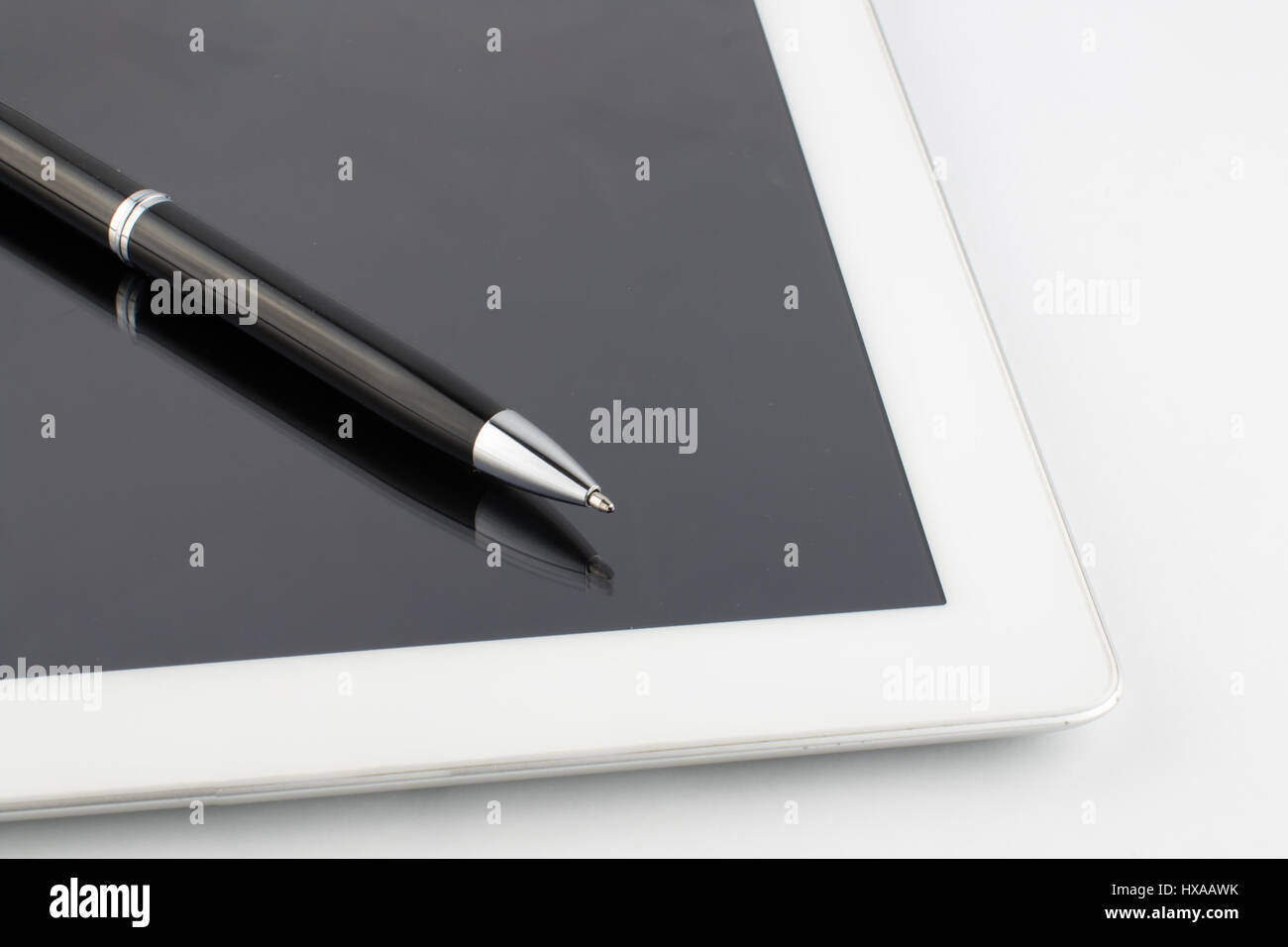 Tablet computer and a modern metal pen on a white background Stock ...