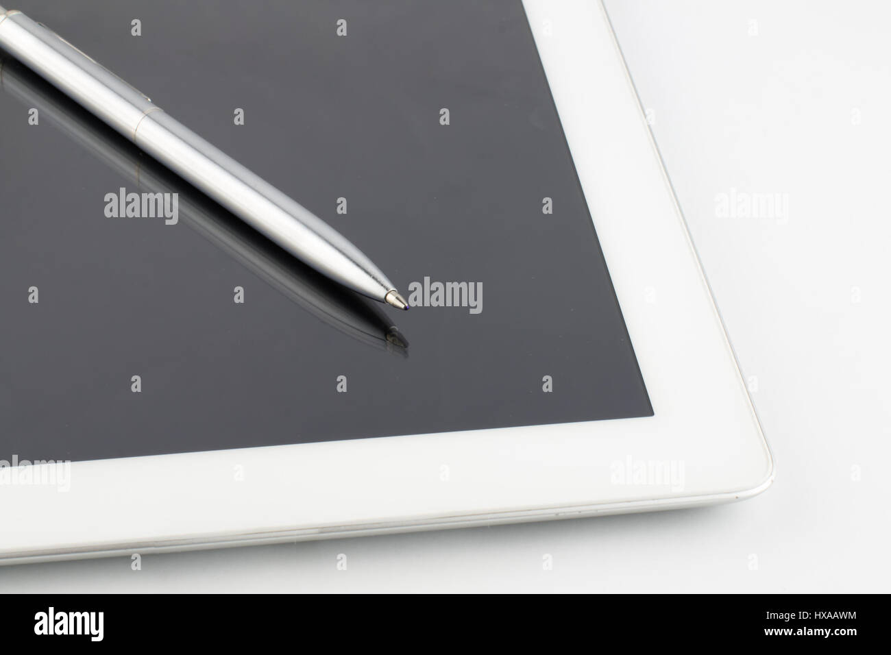 Tablet computer and a modern metal pen on a white background Stock ...