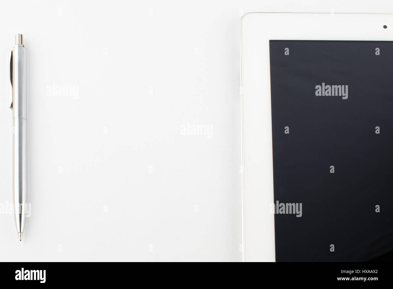 Tablet computer and a modern metal pen on a white background Stock ...