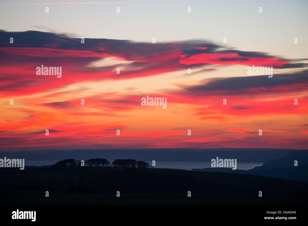 A fiery red sunset over west Dorset towards West Bay and Lyme Regis ...