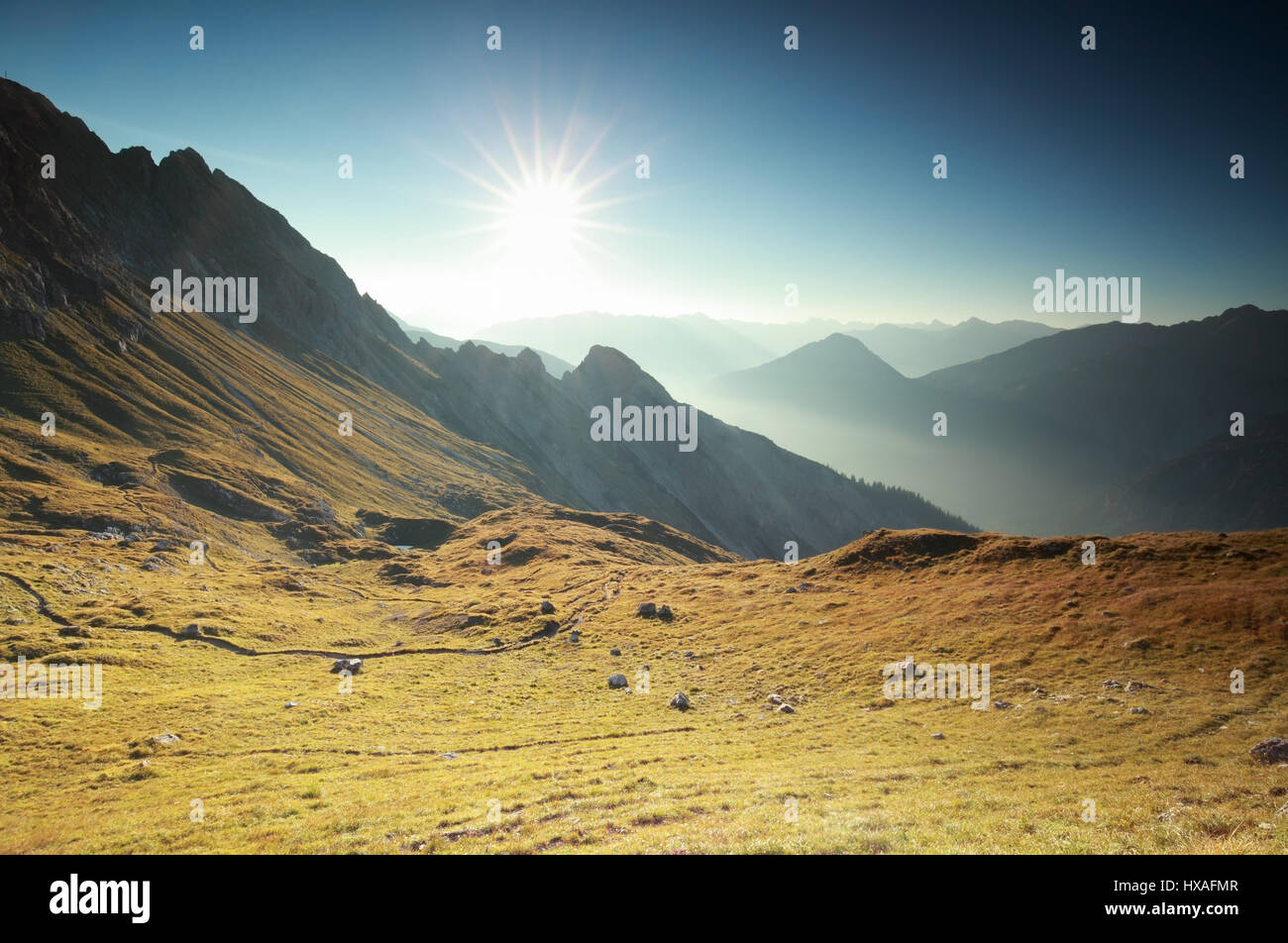 beautiful sunrise over mountain peaks in Alps Stock Photo - Alamy