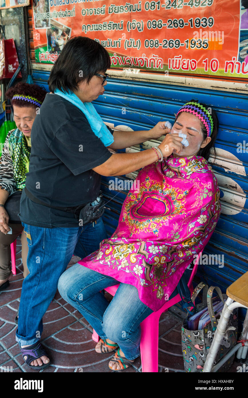 Facial epilation with the ancient method of threading in China town ...