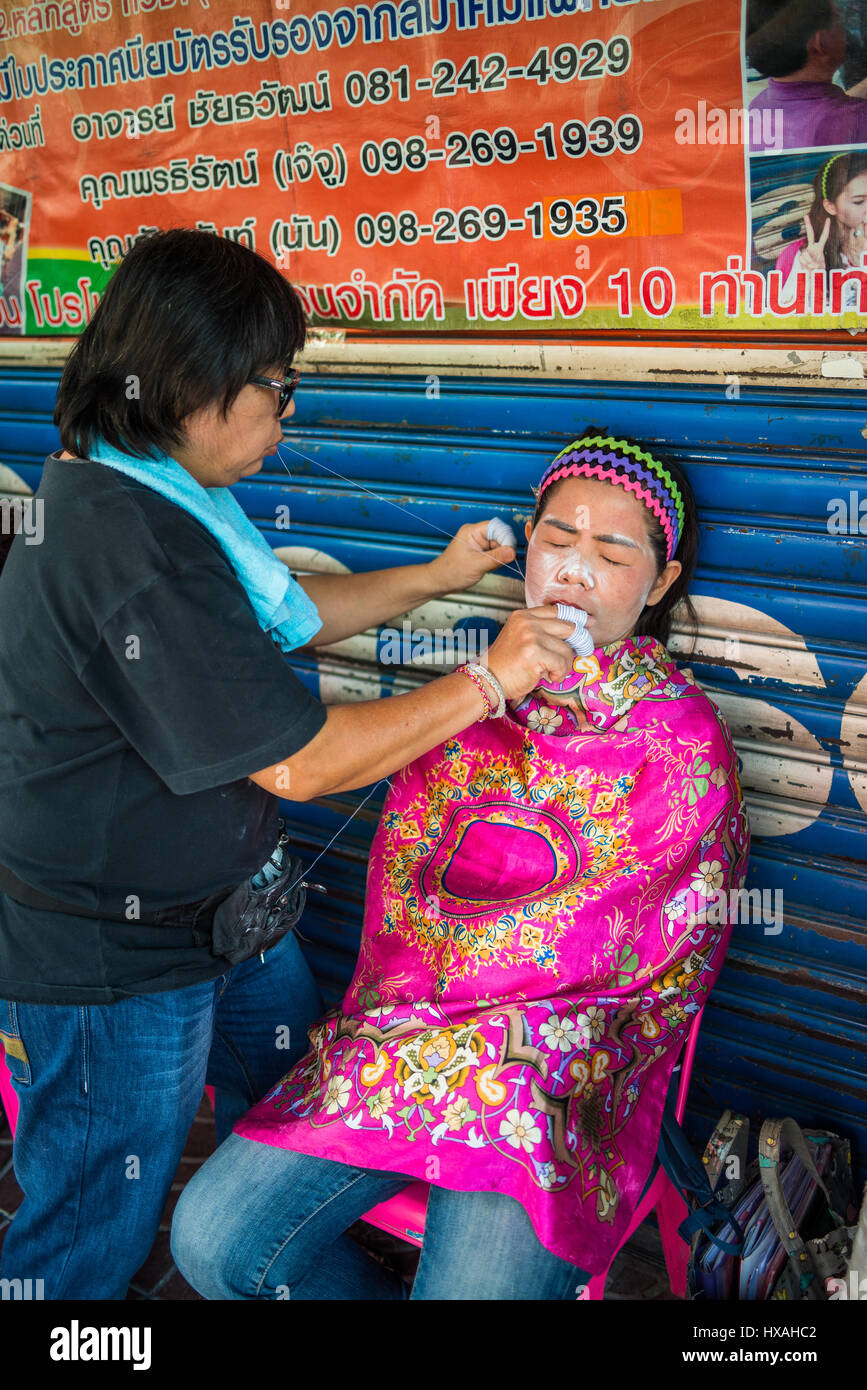 Facial epilation with the ancient method of threading in China town ...