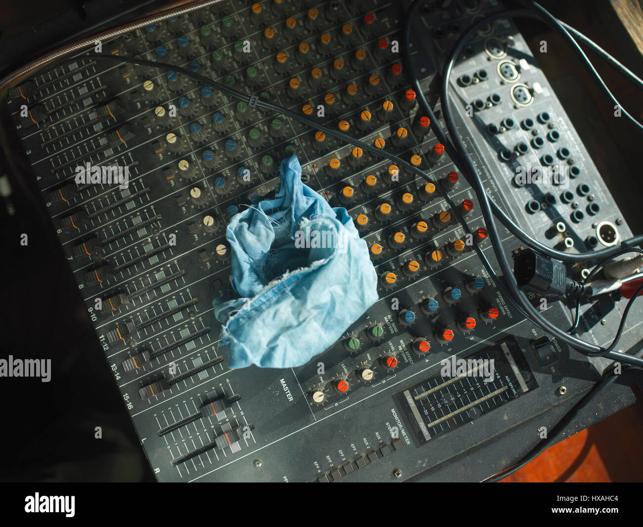Cloth laid on a dusty mixing console in recording studio, overhead shot ...