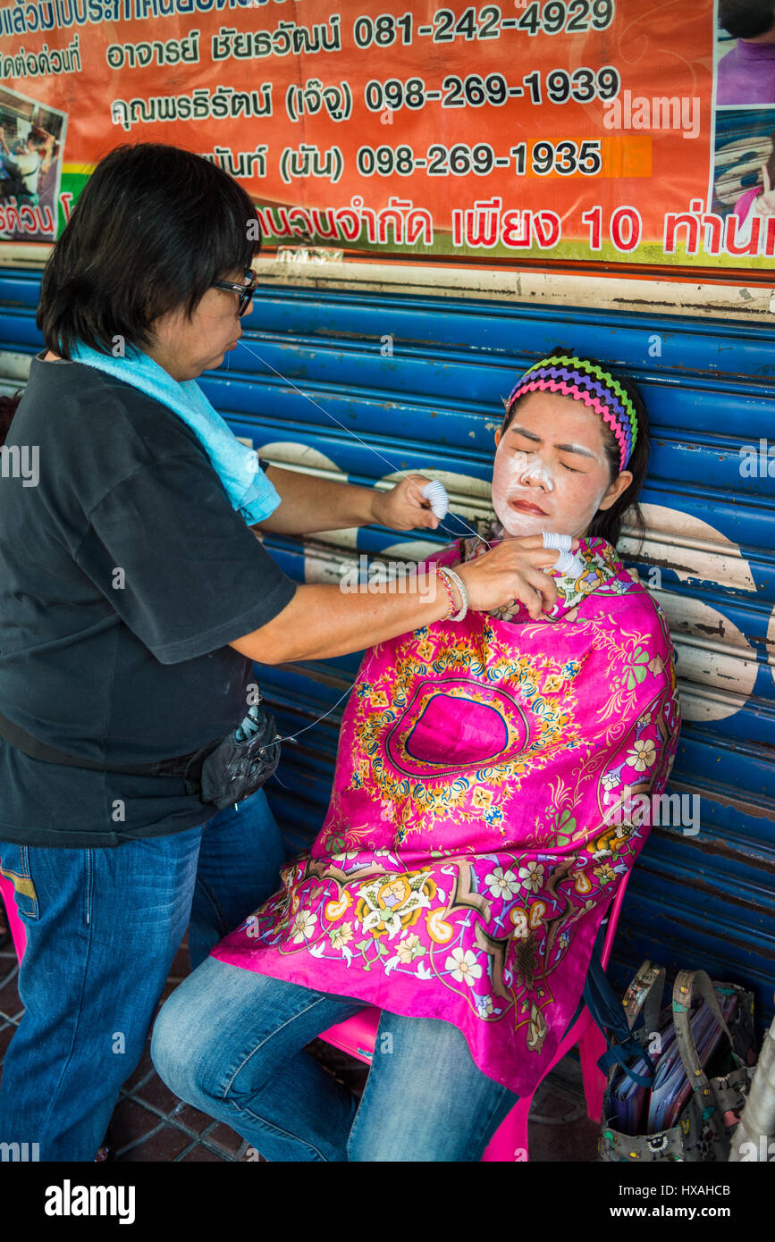 Facial epilation with the ancient method of threading in China town ...