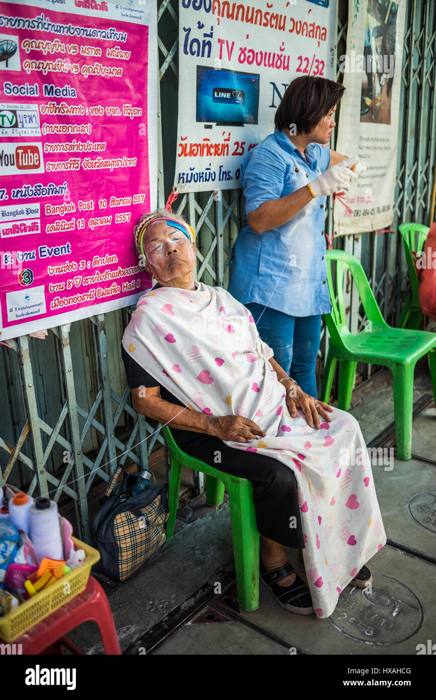 Facial epilation with the ancient method of threading in China town ...