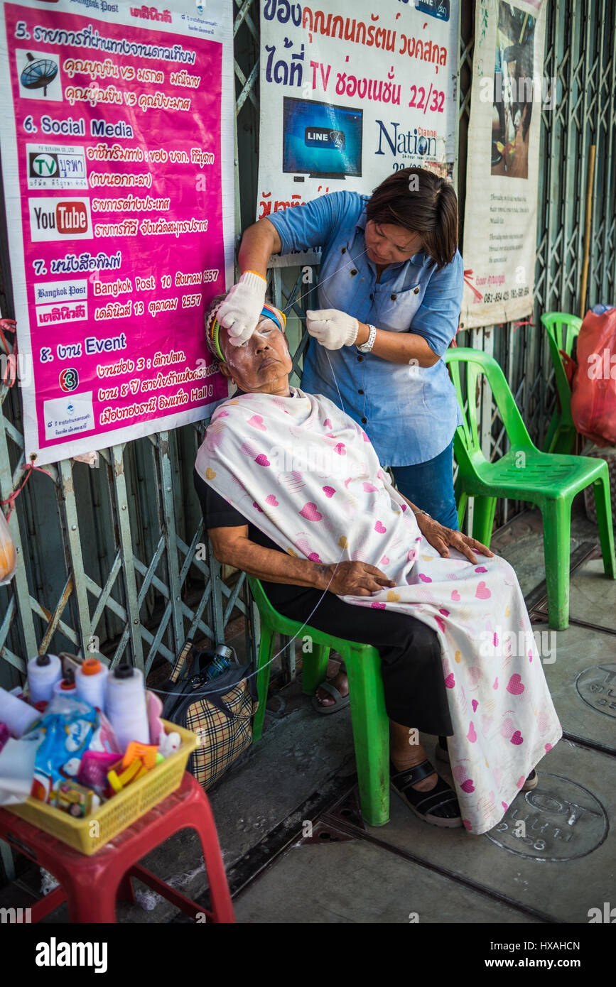 Facial epilation with the ancient method of threading in China town ...