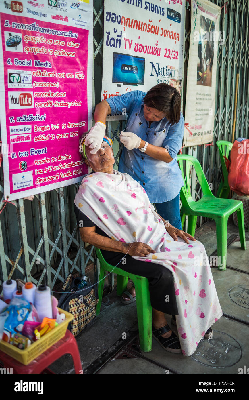 Facial epilation with the ancient method of threading in China town ...