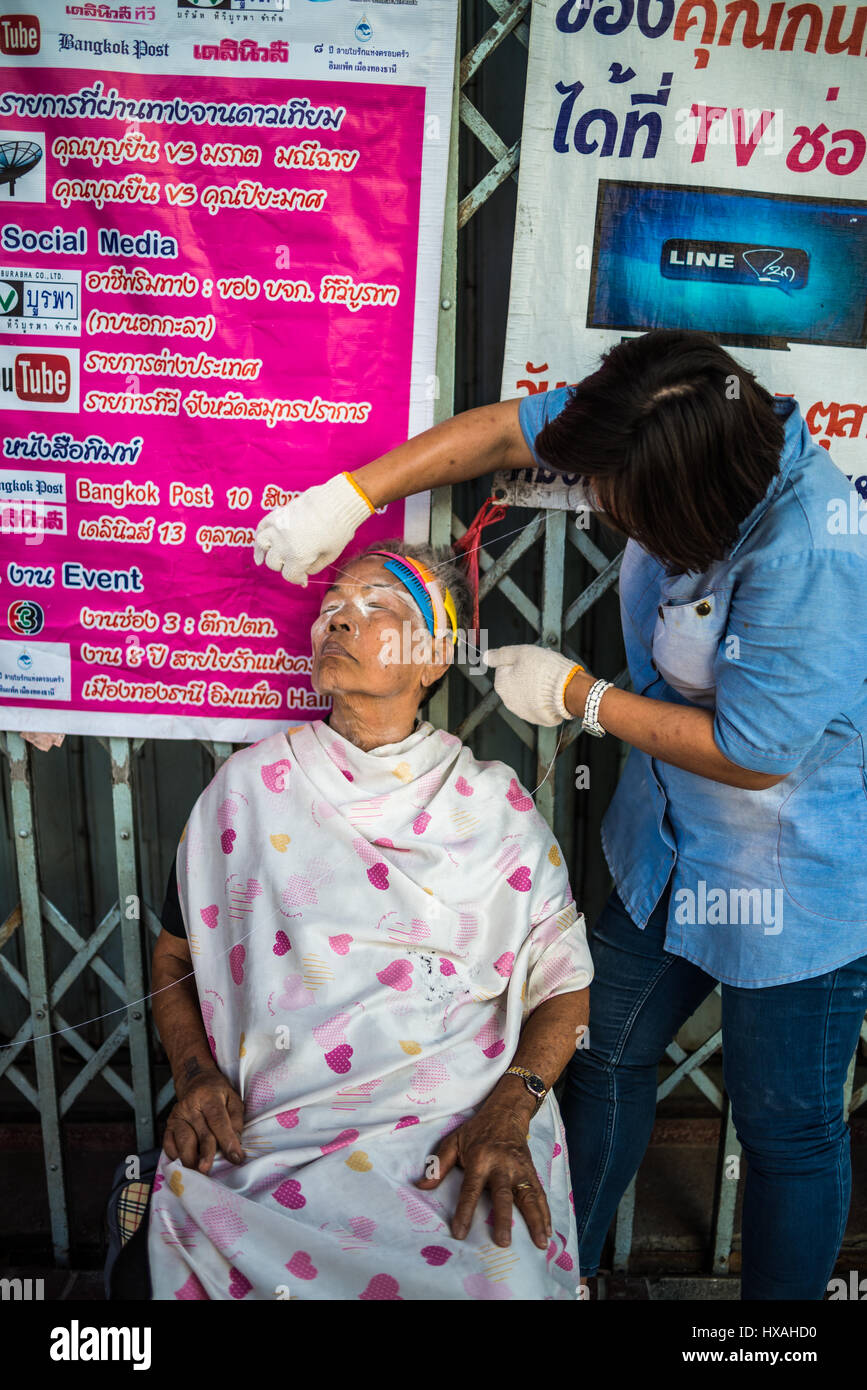 Facial epilation with the ancient method of threading in China town ...