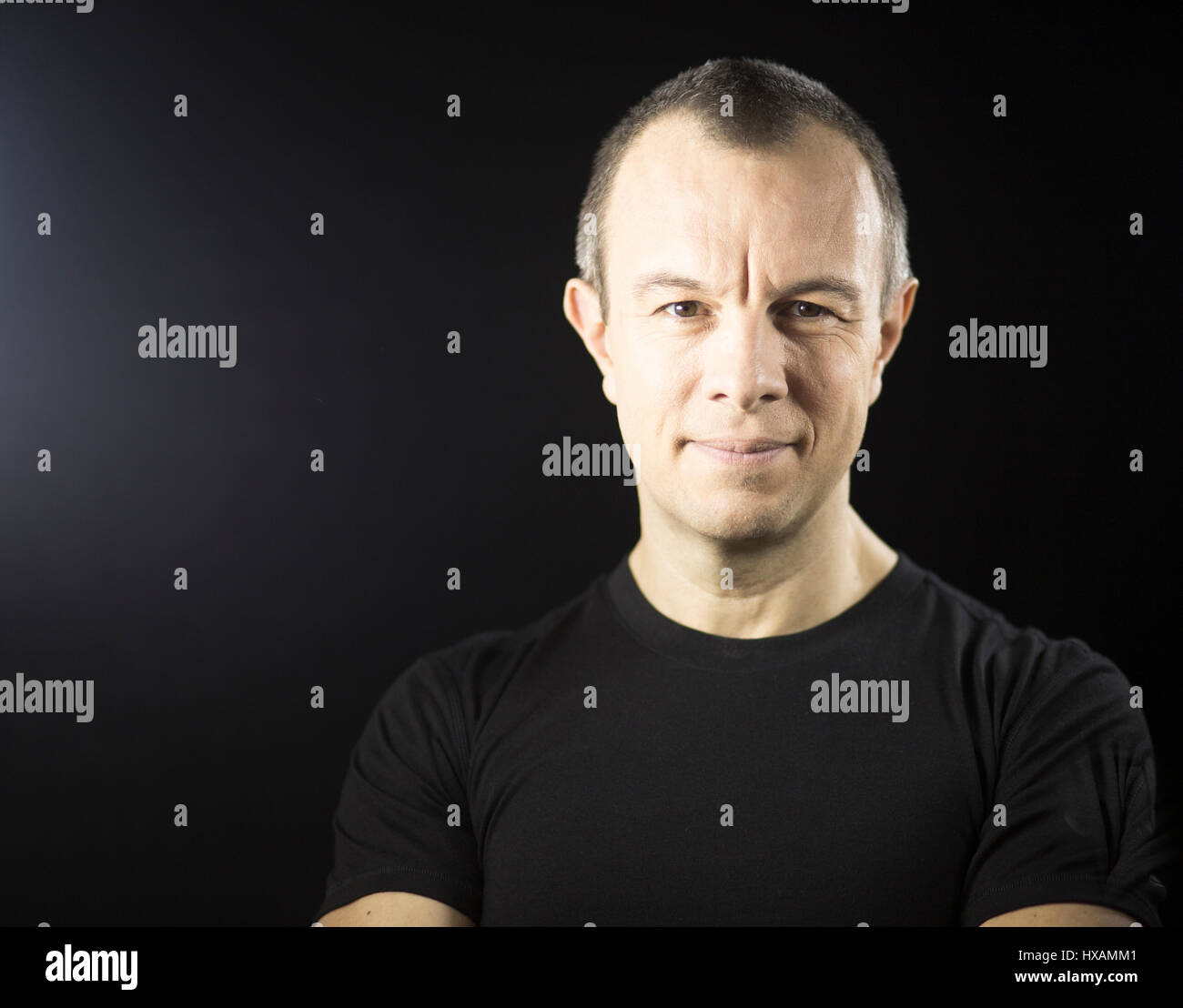 Attractive handsome slim healthy man aged in 40's in black t-shirt ...