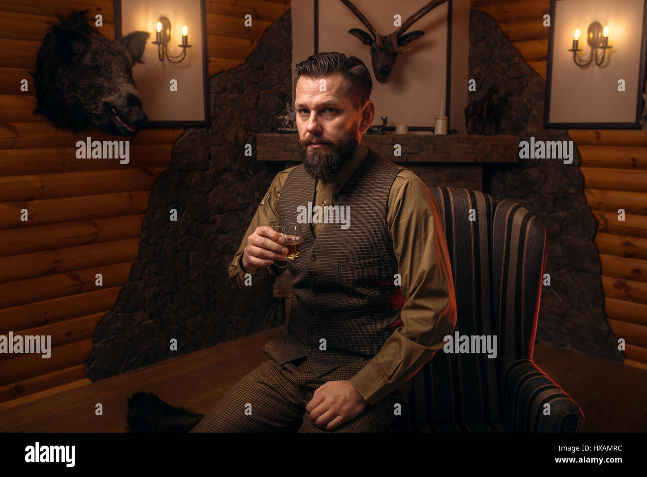 Hunter man in traditional vintage hunting clothing drink luxury alcohol ...