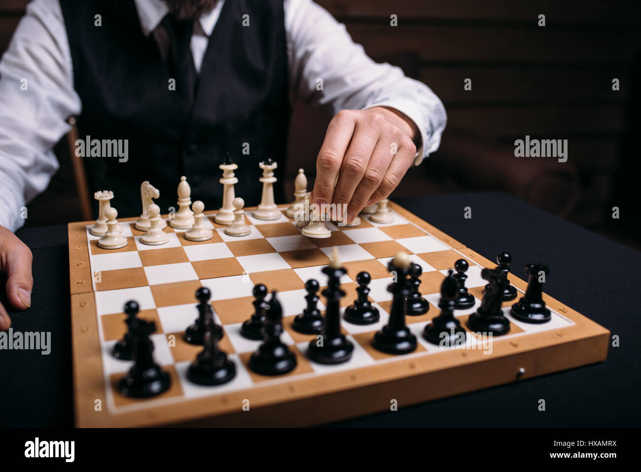 Serious male chess player in glasses makes victory move. Win strategy ...