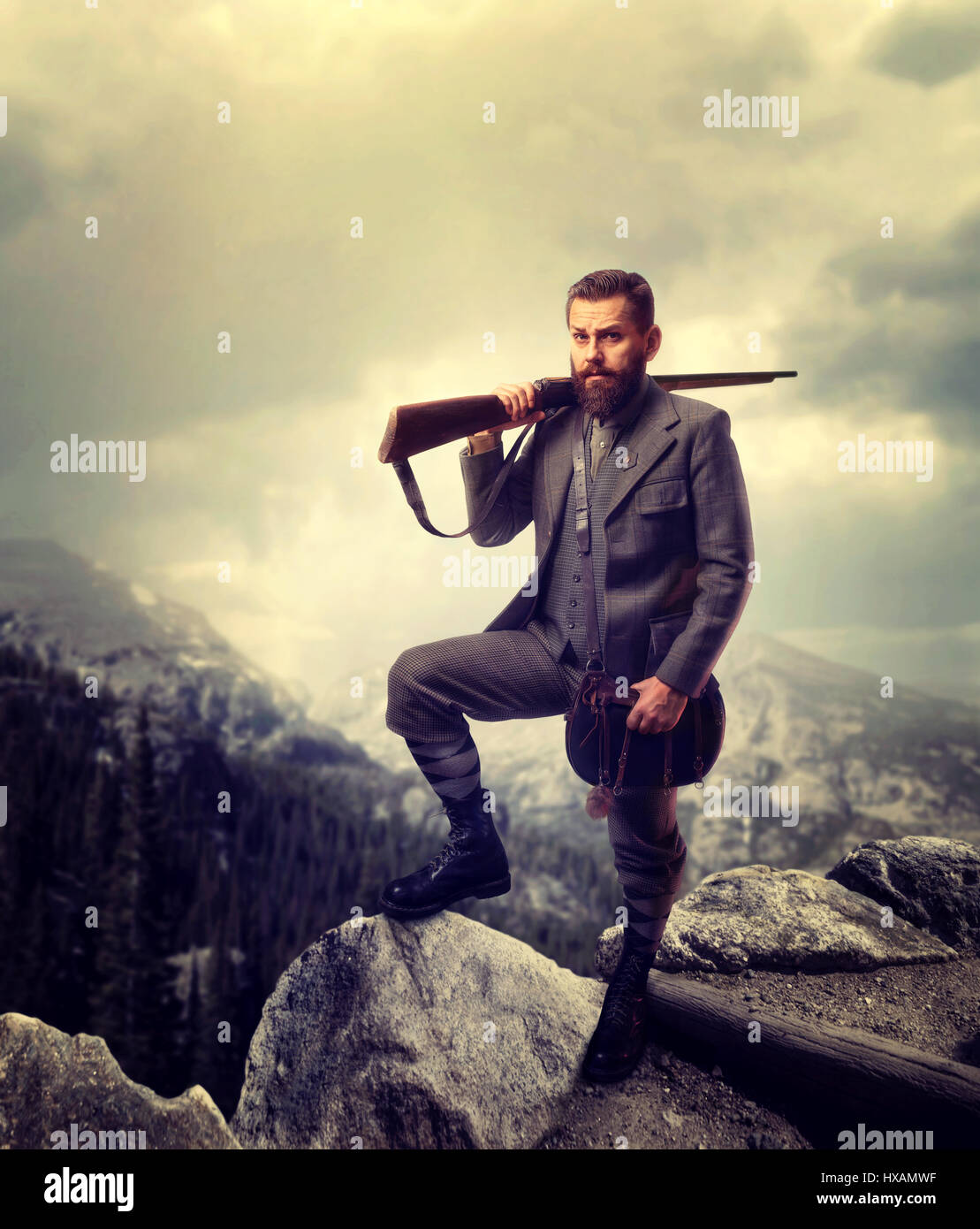 Bearded hunter man in old-fashioned hunting clothing with antique gun ...