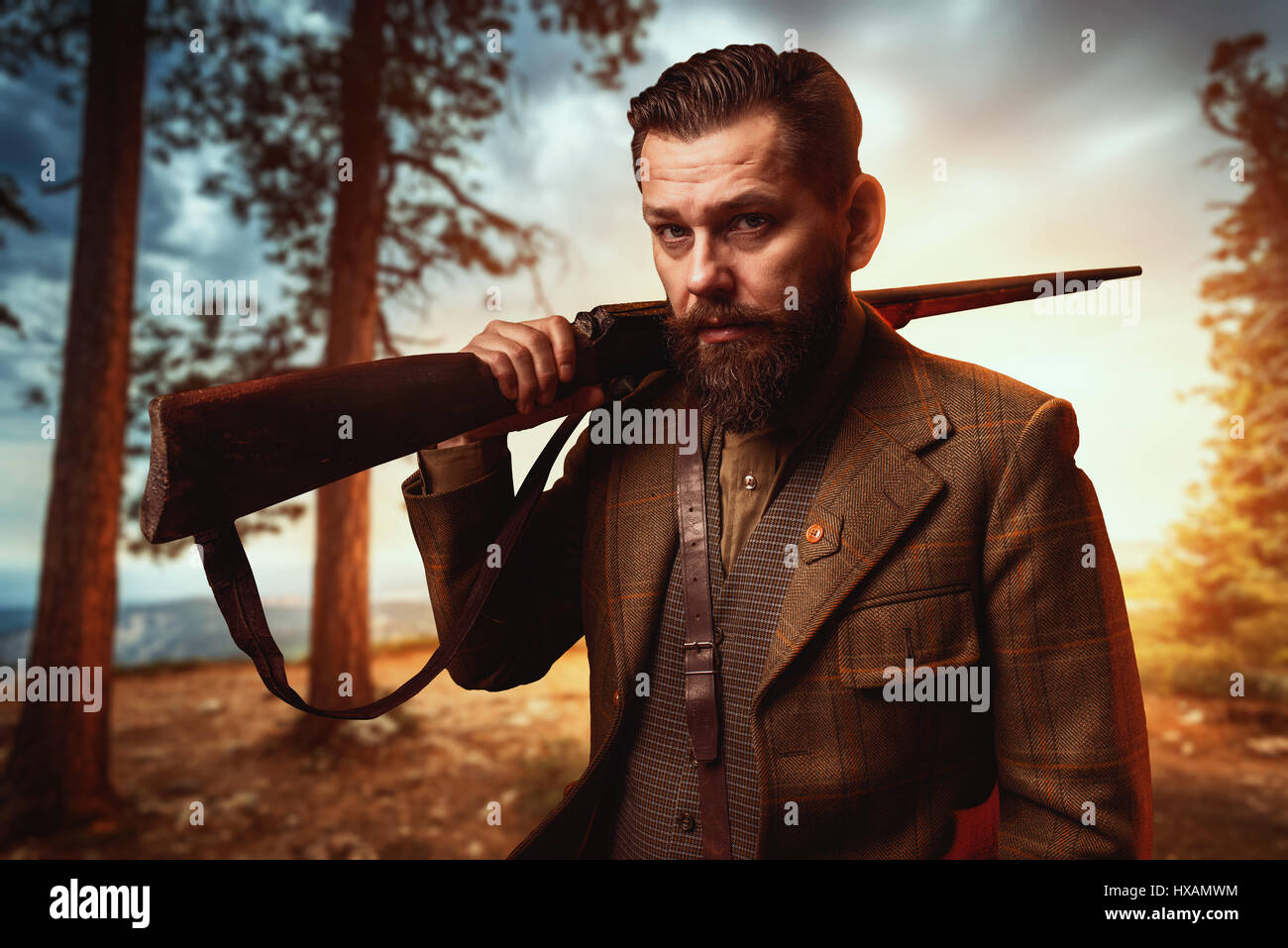 Hunter man in vintage hunting clothing with old gun, forest on ...