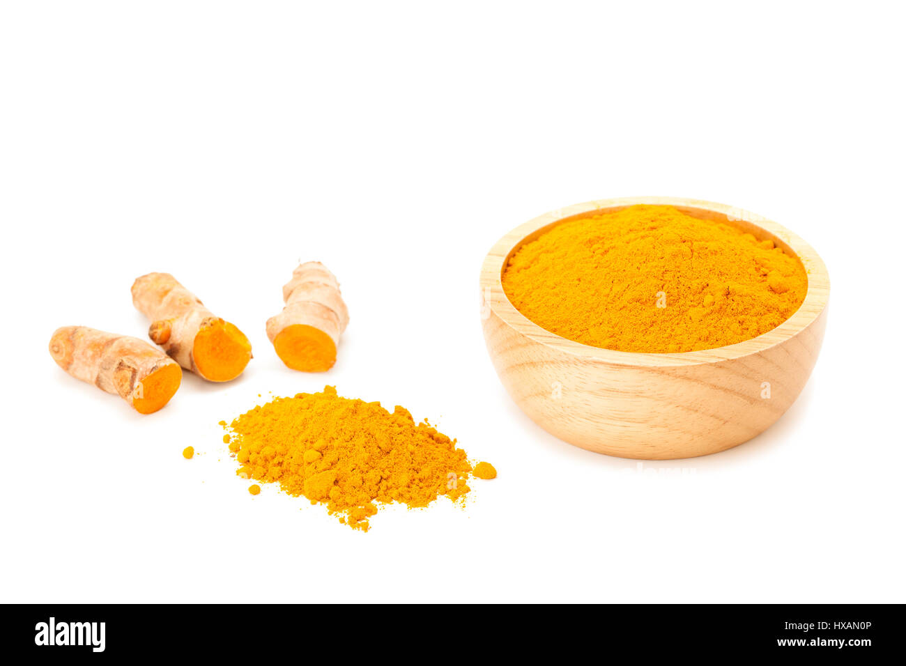 Turmeric rhizome and turmeric powder in wooden bowl isolated on white ...
