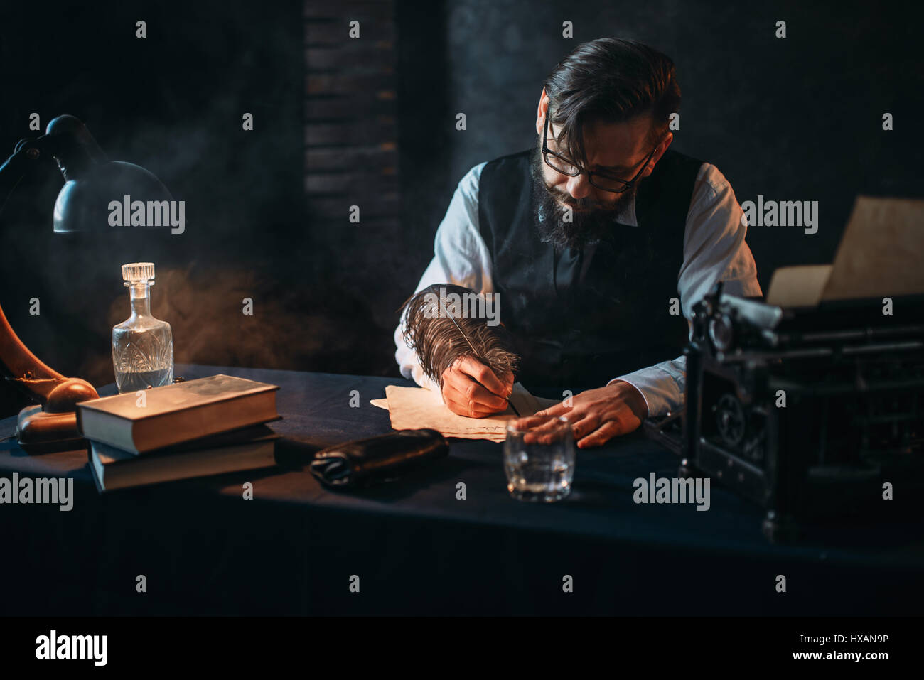 Bearded writer in glasses writes with a feather. Retro typewriter ...