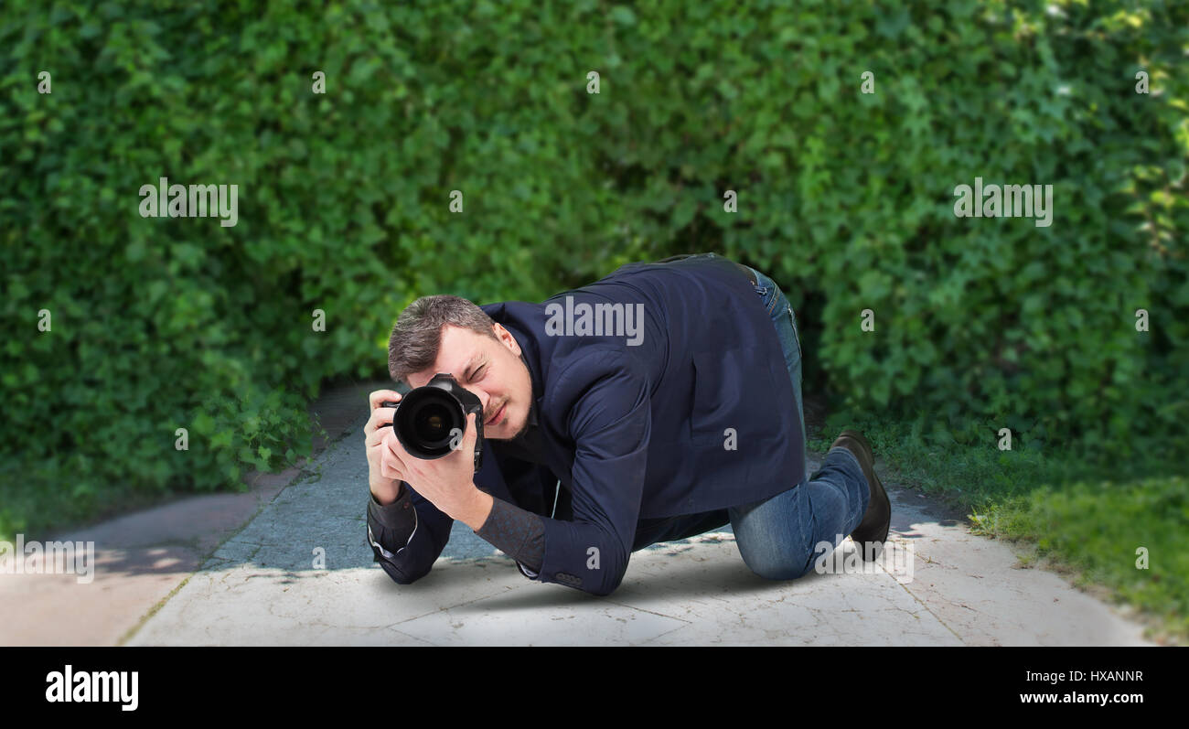 Male squat photographing on digital camera with professional lens Stock ...