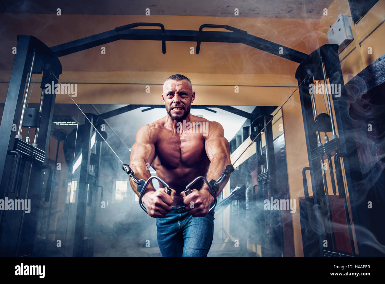 Bodybuilder Is Working On His Chest With Cable Crossover In Gym. Smoke ...