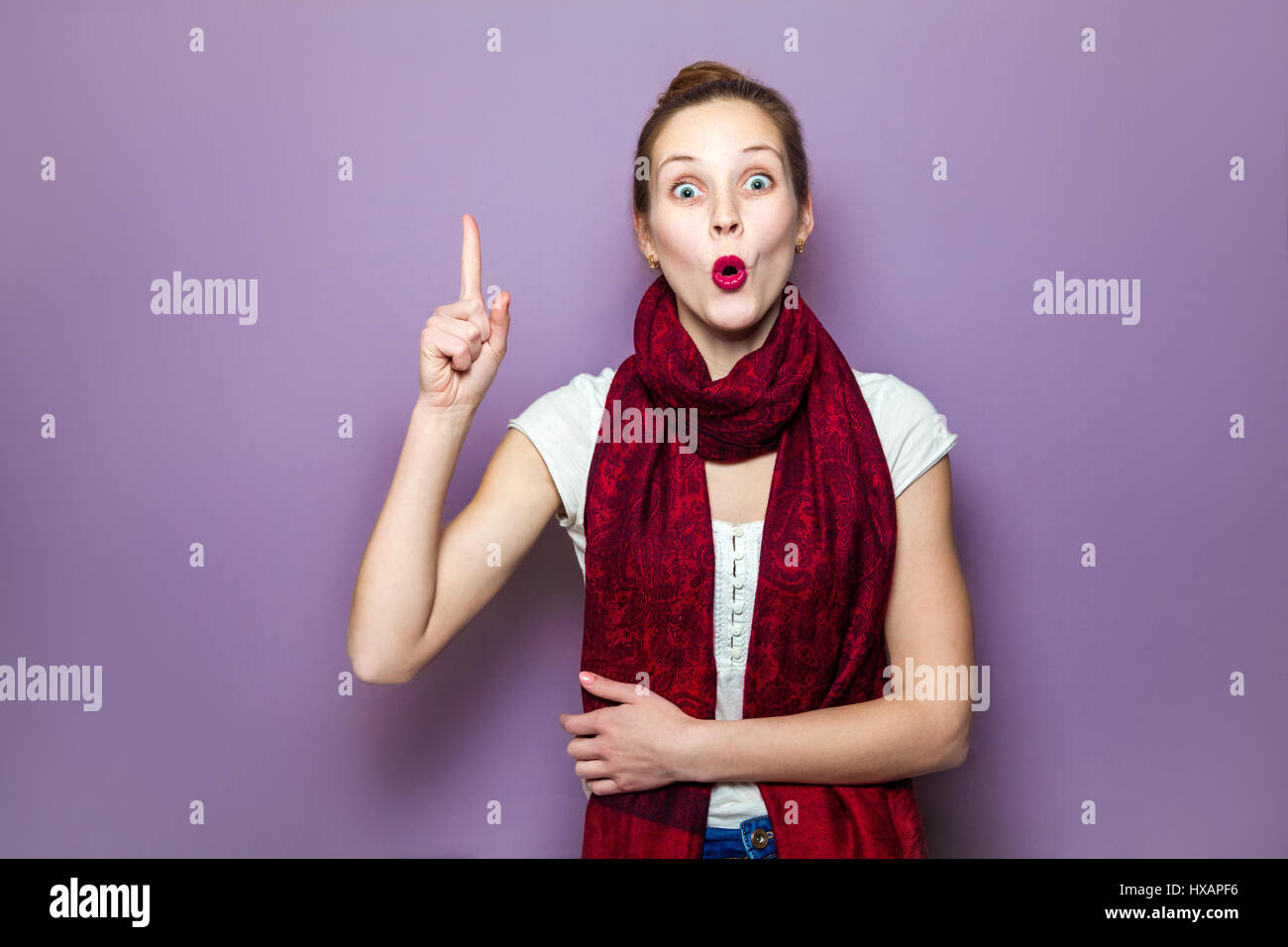 Idea, portrait happy beautiful woman thinking looking up pointing with ...