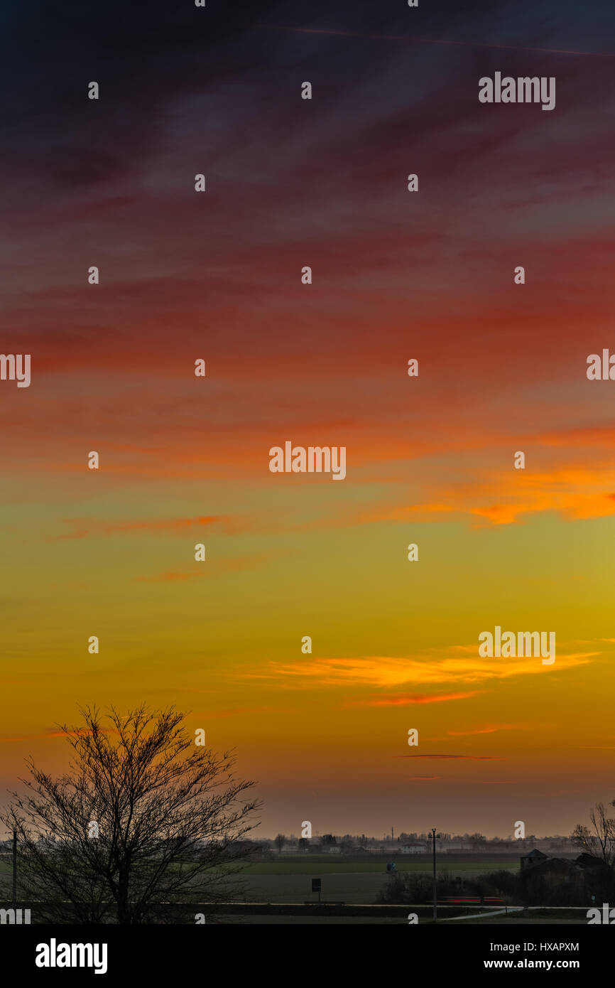 red cloudy sunset in winter on countryside in silhouette Stock Photo ...