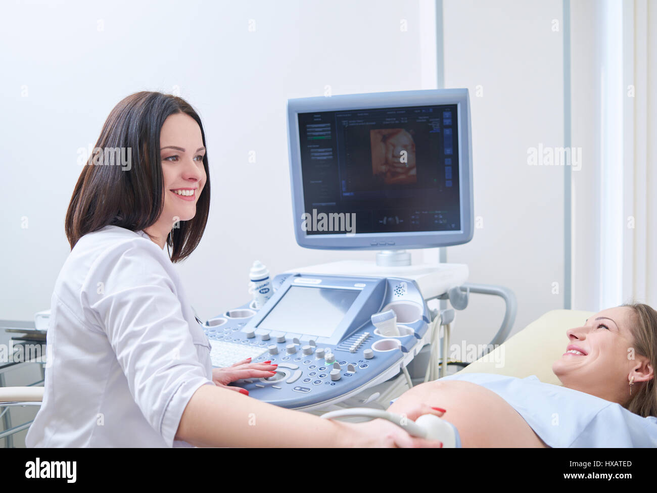 Pregnant woman having ultrasonic scanning at the clinic Stock Photo - Alamy