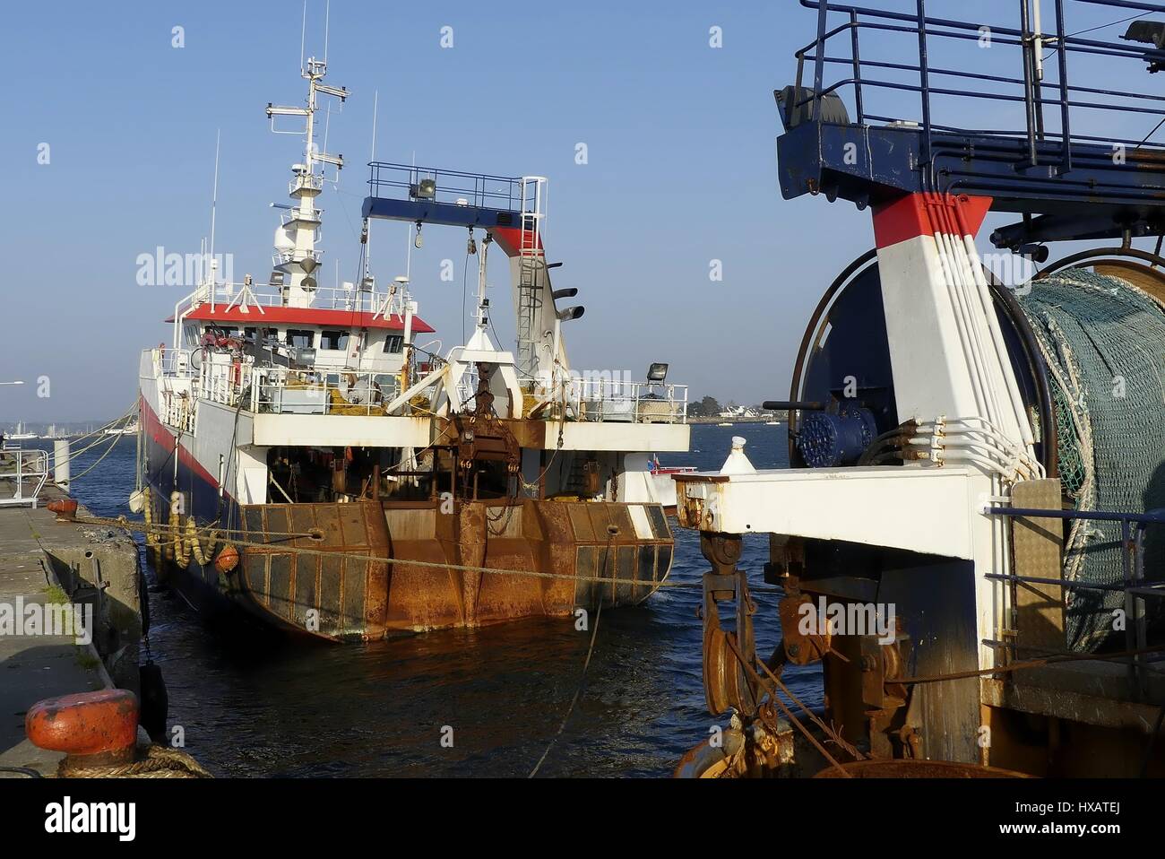 Stern view of Trawler fishing boats with rolled up fishing nets and ...
