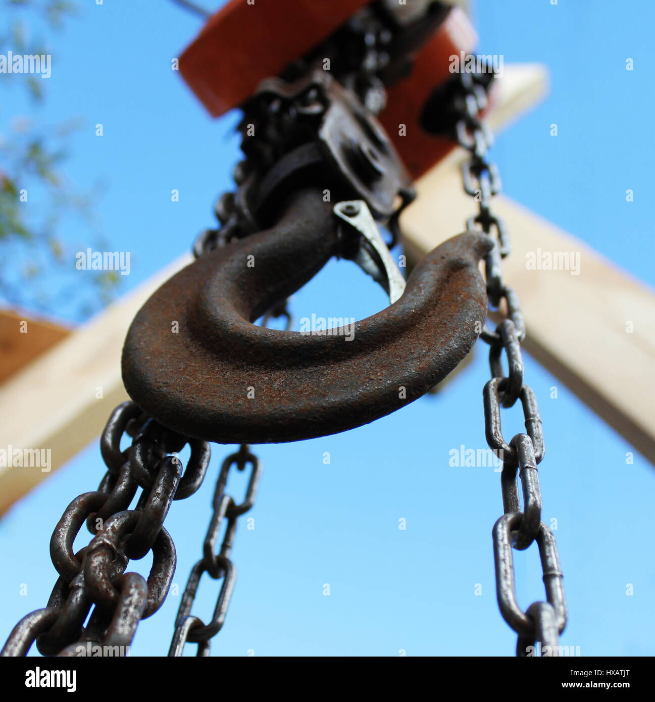 Old rusty hook on blue sky background. Construction industry. Ready to ...