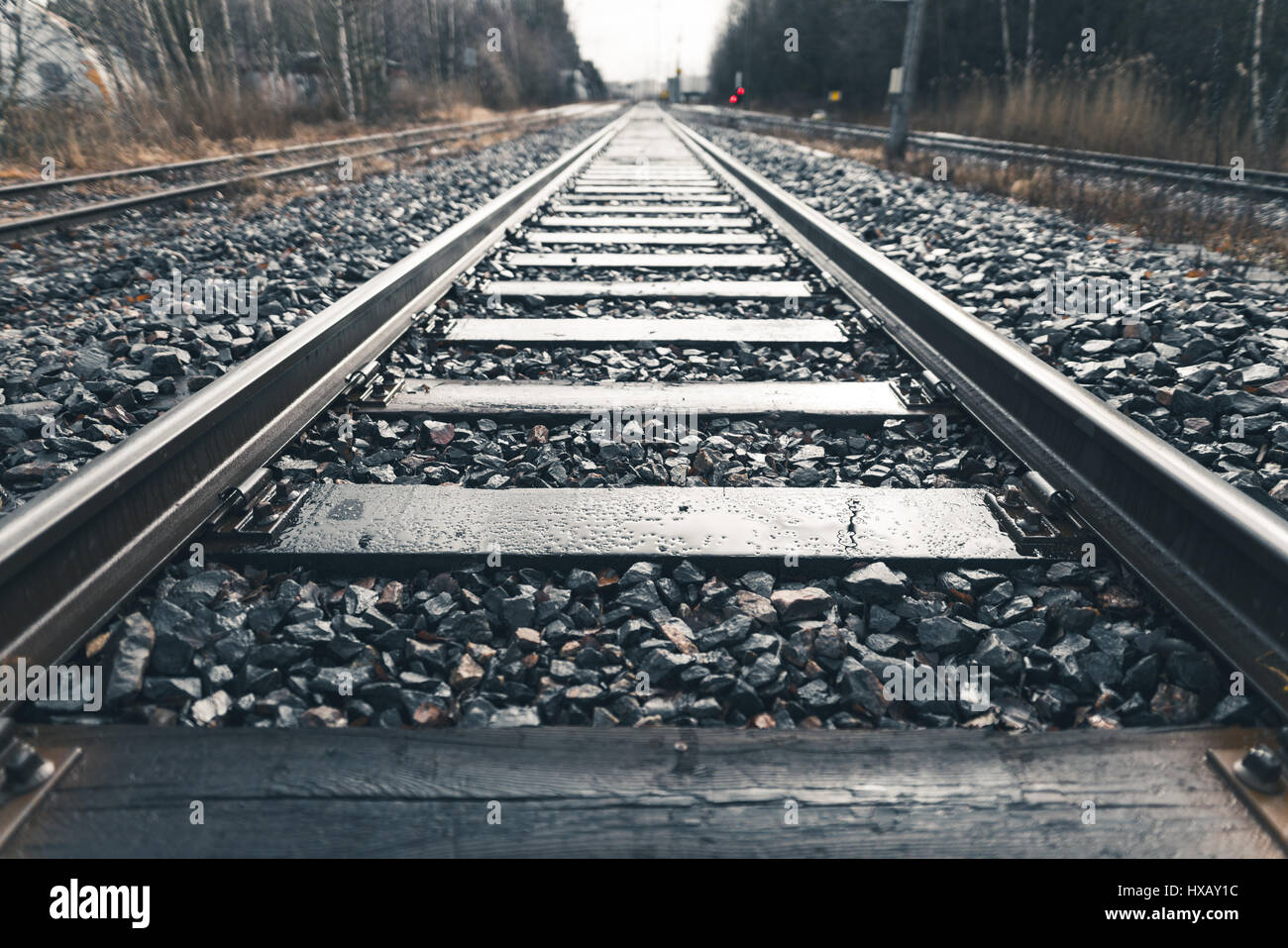 wide and low angle view of railroad tracks with high contrast and ...