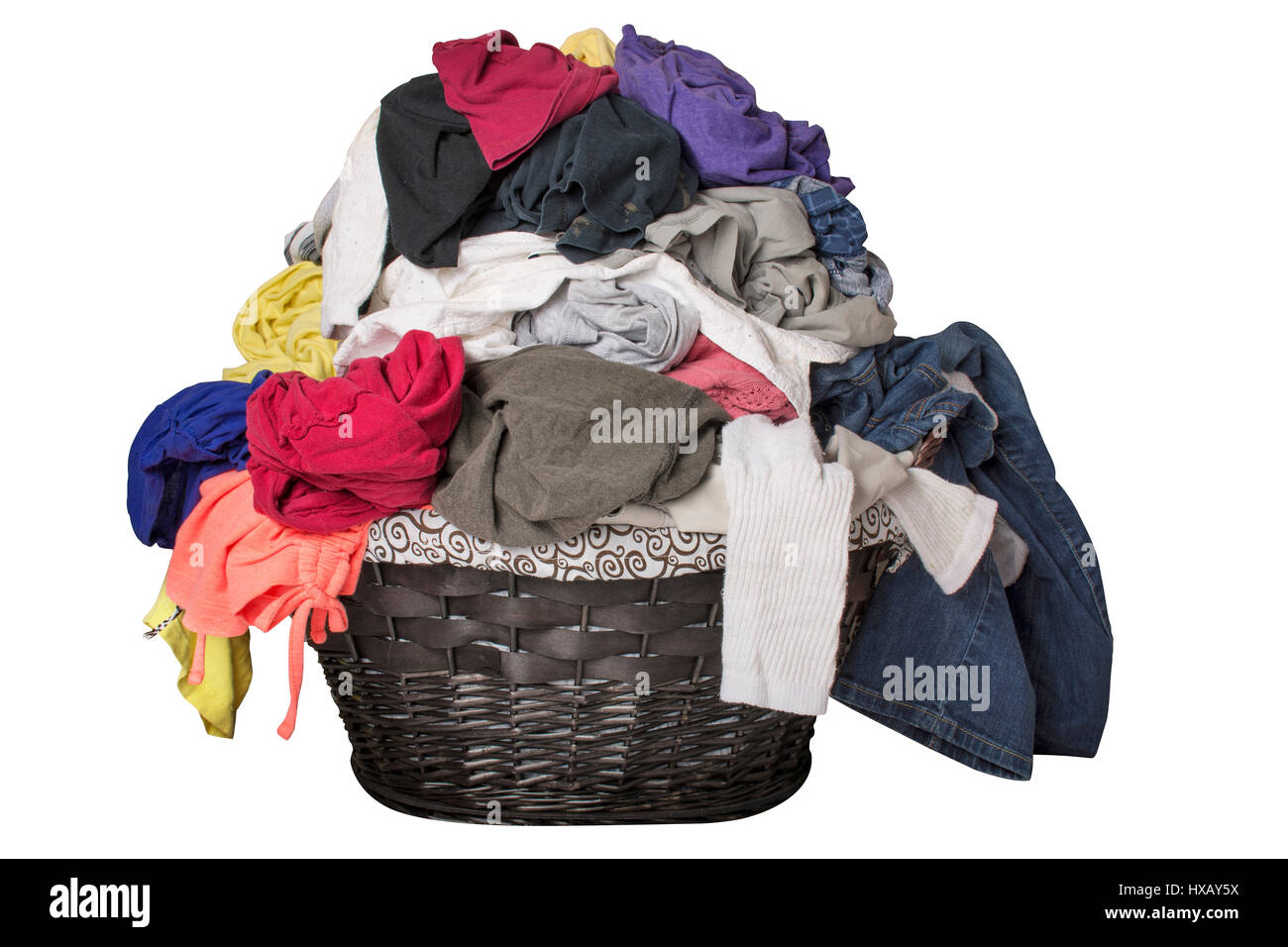 Dirty laundry piled up overflowing in a black basket, isolated on white ...