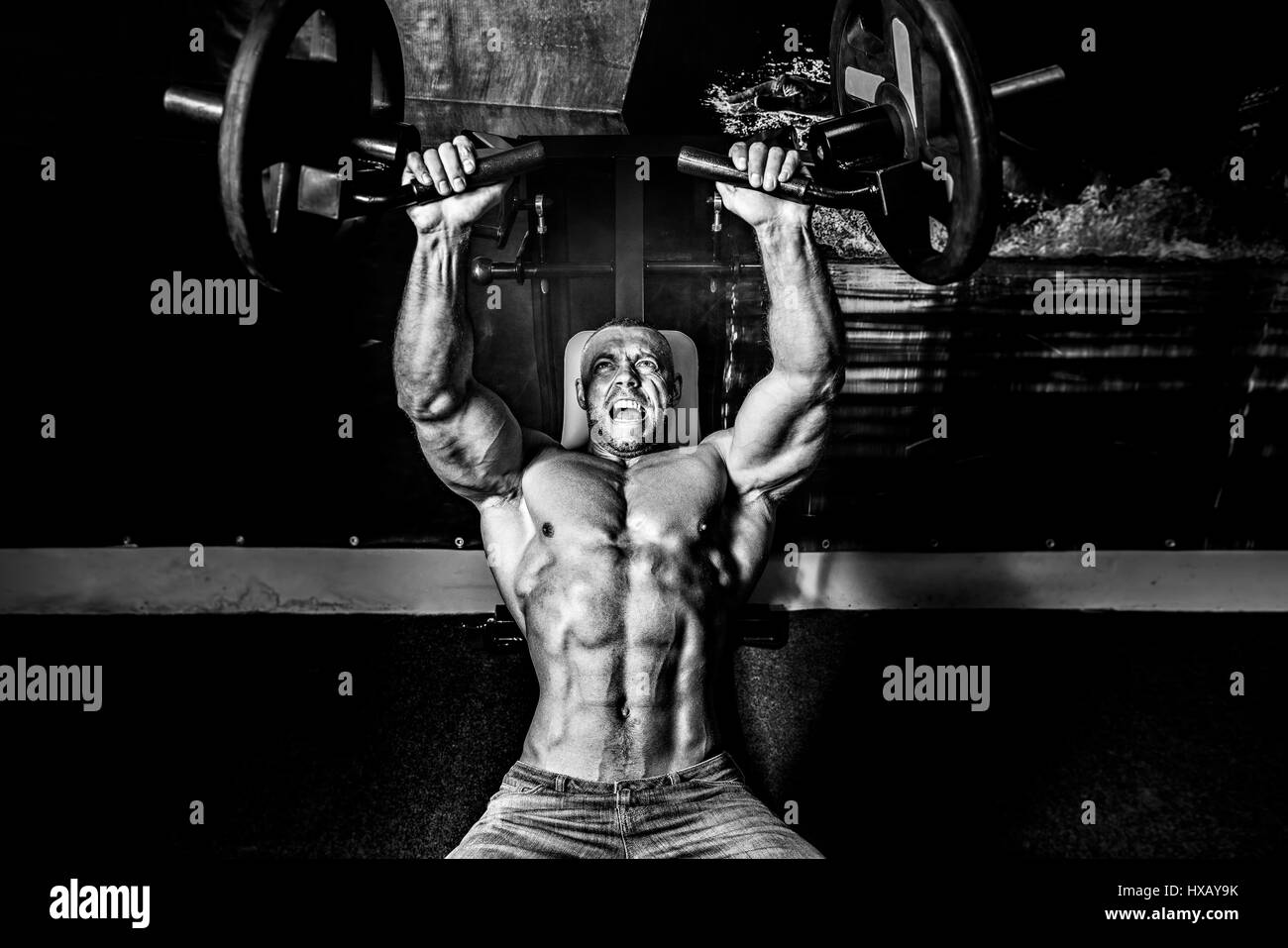 The athlete doing exercises on pectoral muscles in smoke. GYM Stock ...