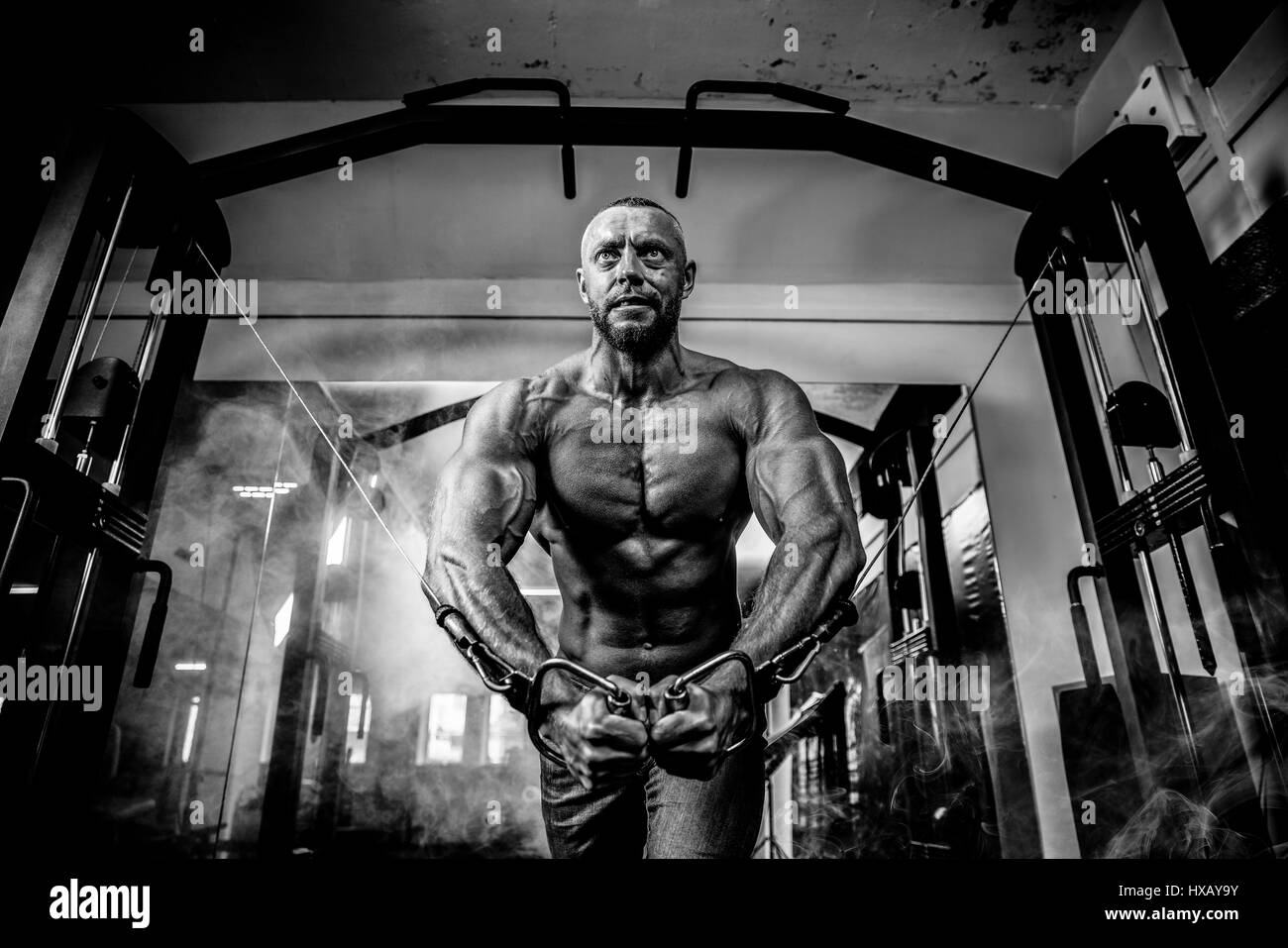 Bodybuilder Is Working On His Chest With Cable Crossover In Gym. Smoke ...