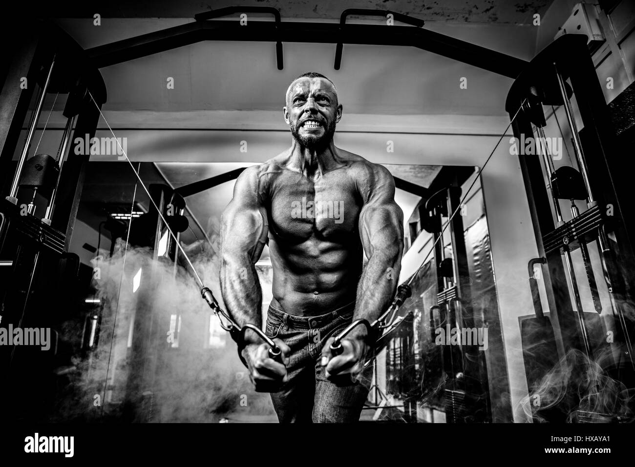 Bodybuilder Is Working On His Chest With Cable Crossover In Gym. Smoke ...