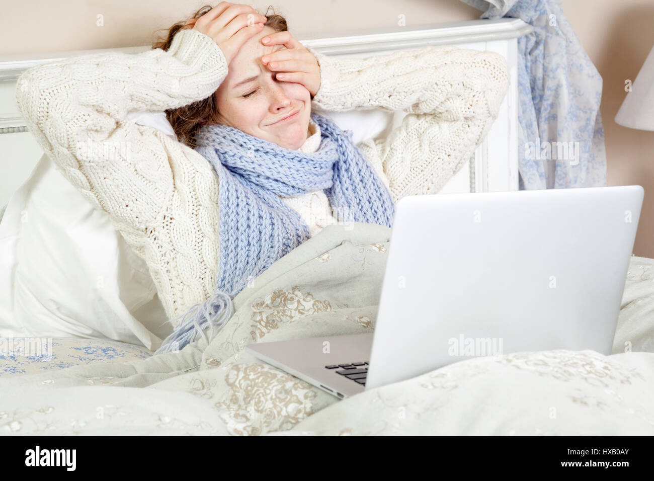 Sick woman feeling bad, resting and working with her laptop and ...