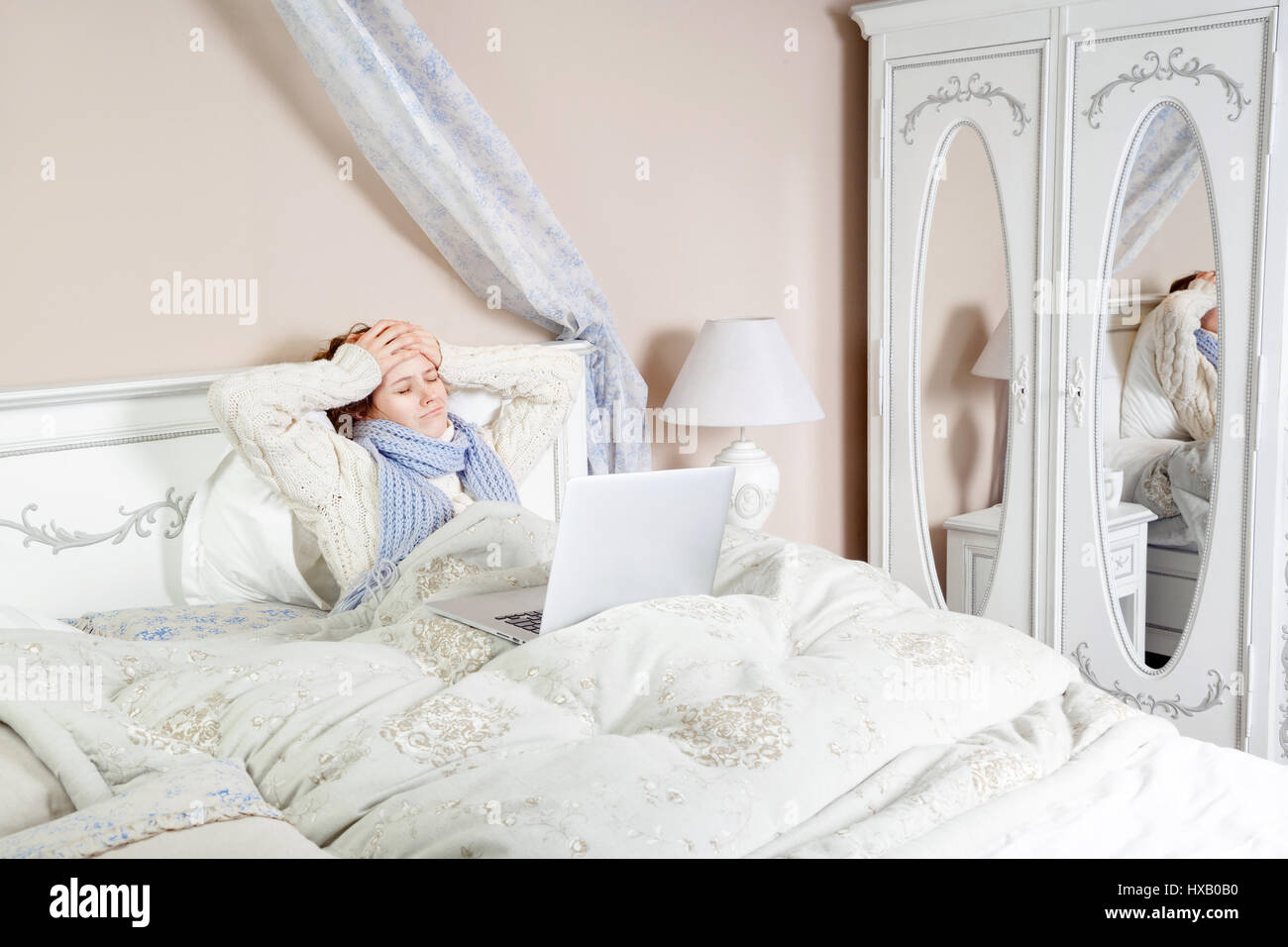 Sick woman feeling bad, resting and working with her laptop and ...