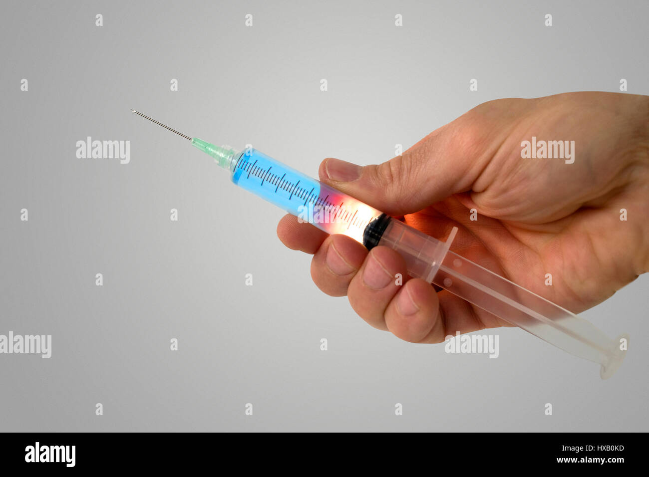 Illuminated drug inside a medical syringe Stock Photo - Alamy