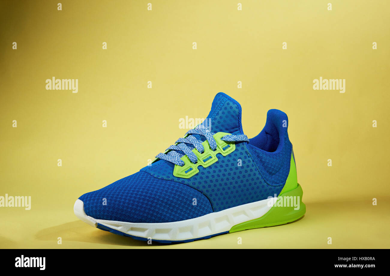 New modern trainer shoe on 45 degree view isolated yellow background ...