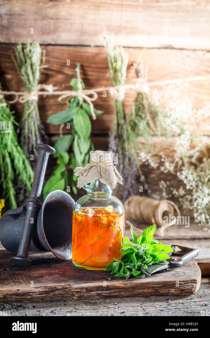 Therapeutic herbs in bottles as homemade cure Stock Photo - Alamy