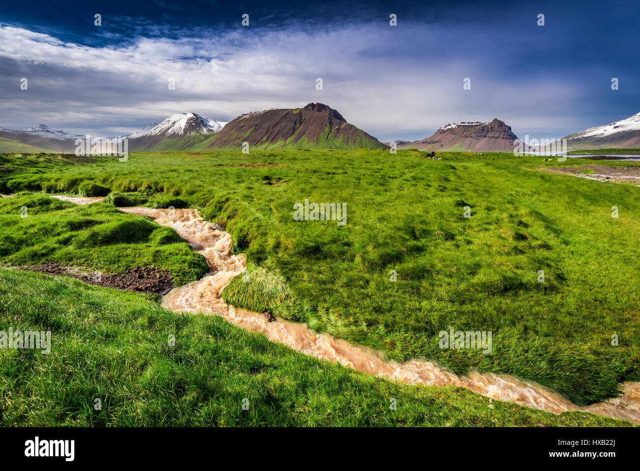 Stream flowing from mountains after the rain, Iceland Stock Photo - Alamy