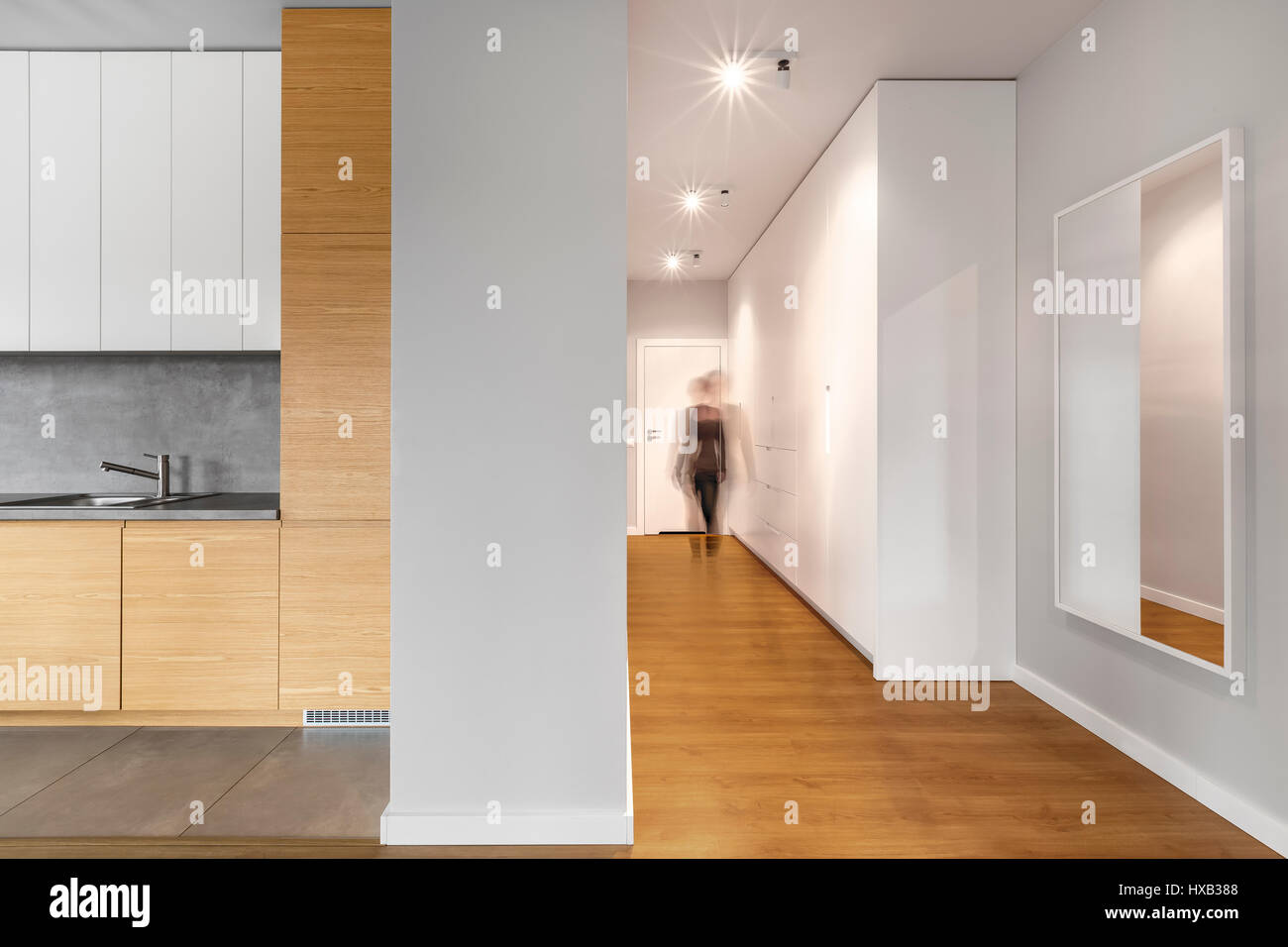 Long modern hallway with large and white wardrobe and big mirror next ...