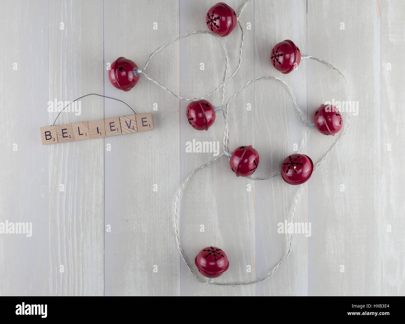 Red Bell Lights with Believe Ornament and copy space Stock Photo - Alamy