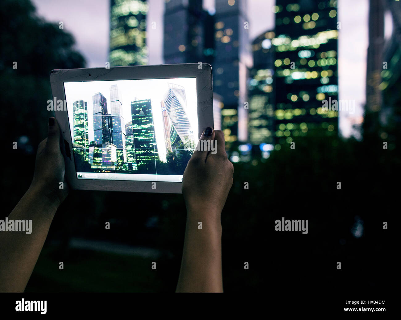Woman tablet night skyline hi-res stock photography and images - Alamy