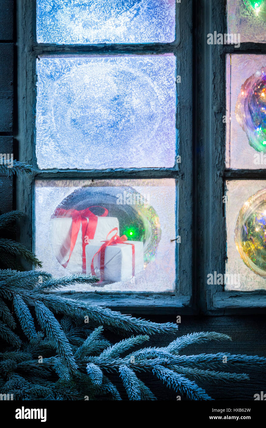Gorgeous gifts for Christmas in frozen window Stock Photo - Alamy